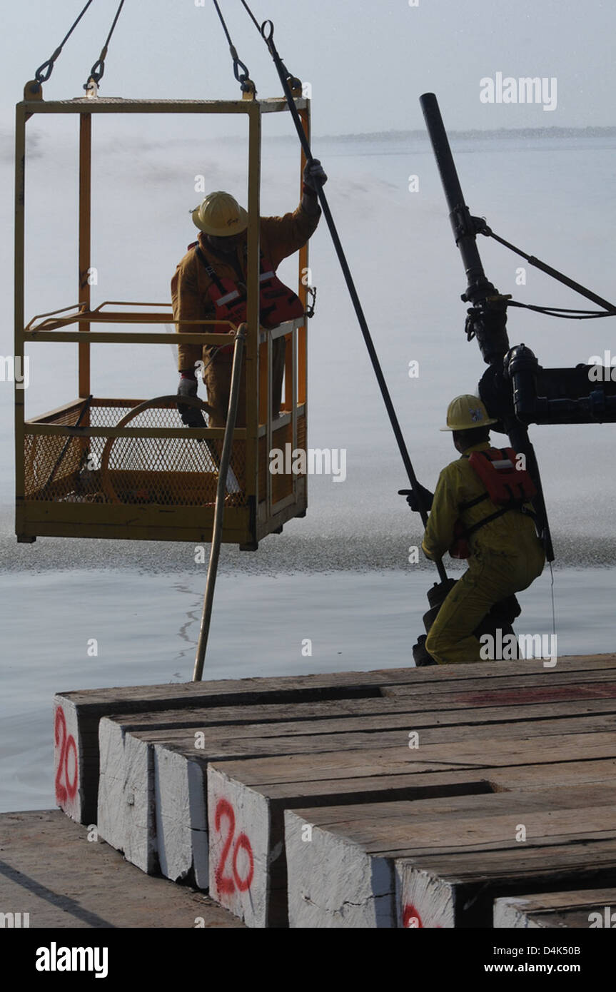 Crews from the Eighth District work to contain a damaged wellhead in ...