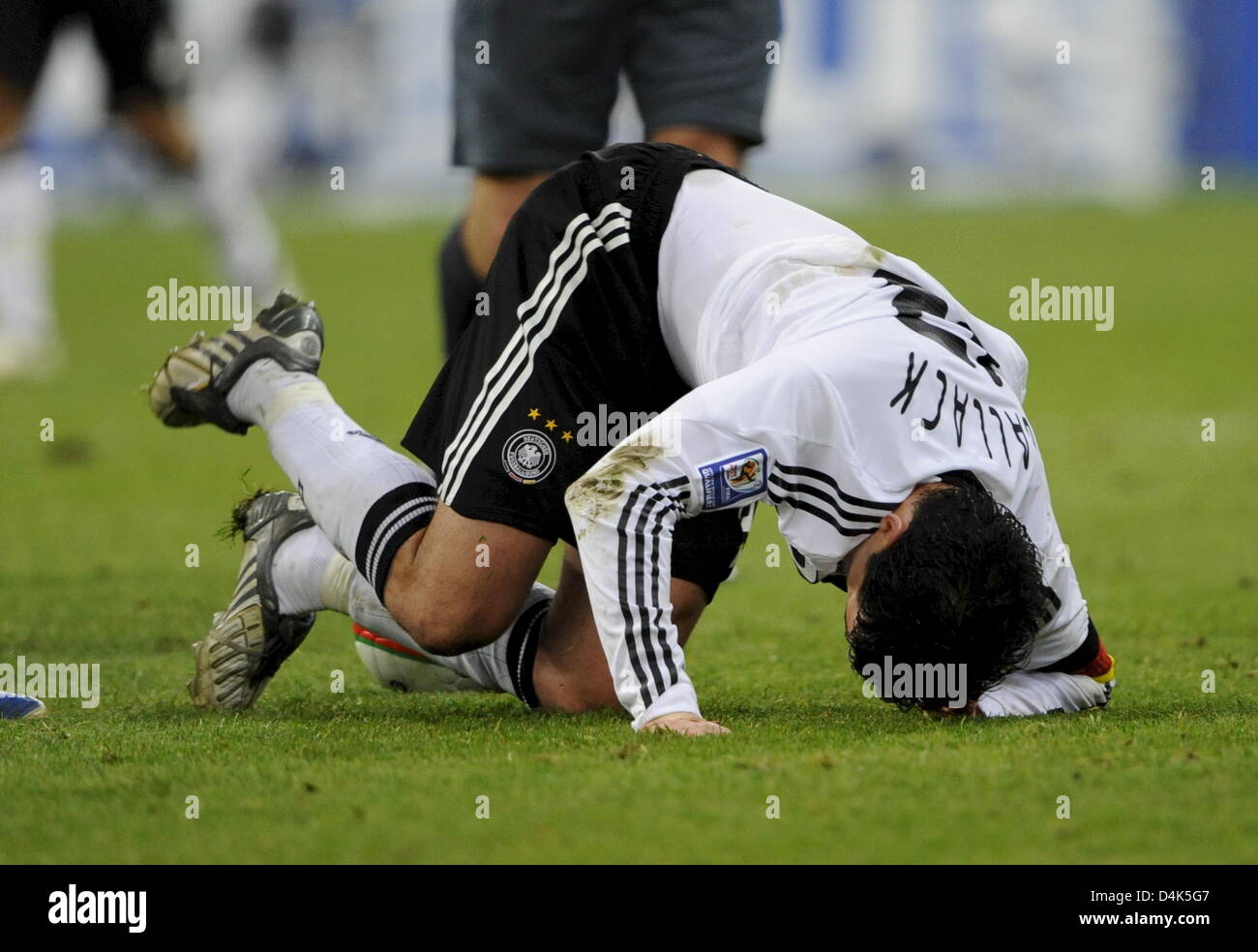 Germany?s captain Michael Ballack lies on the pitch after having been ...