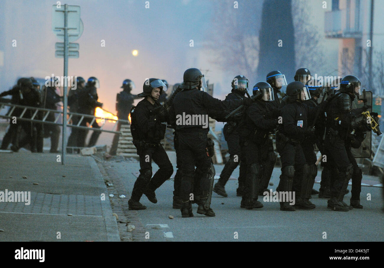 Special units of the French police hide behind plexiglass shields as ...