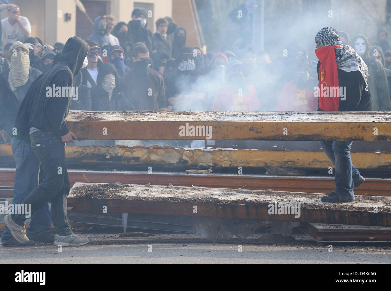 Hooded protestors man a burning barricade against the NATO summit on a ...