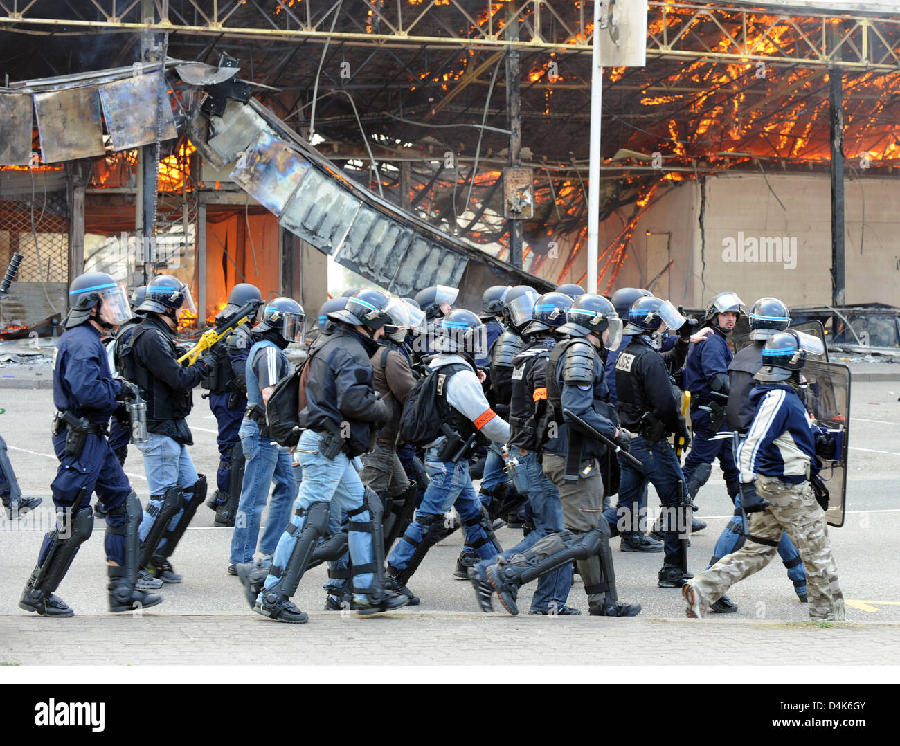 Police forces in riot gear march at the 2009 NATO Summit in Strasbourg ...