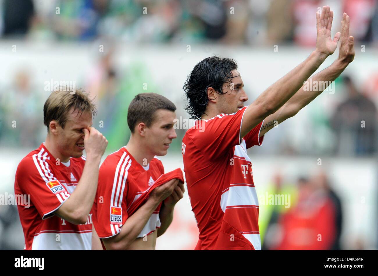 (L-R) Munich?s Christian Lell, Lukas Podolski and Luca Toni look ...