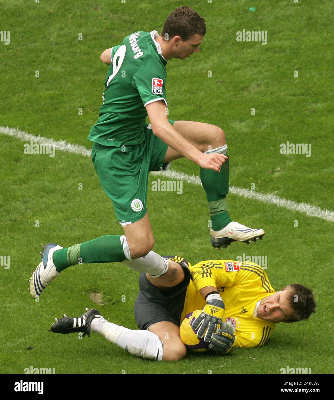 Munich?s goalie Michael Rensing (R) makes the save before Wolfsburg?s ...