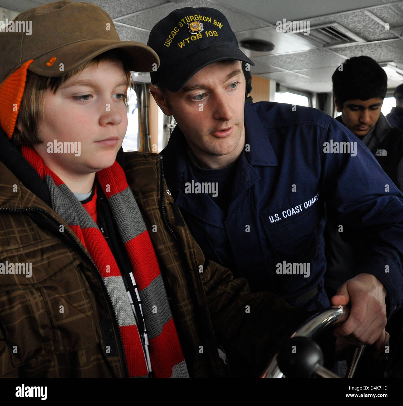 Seaman Cory of the U.S. Coast Guard demonstrates steering techniques ...