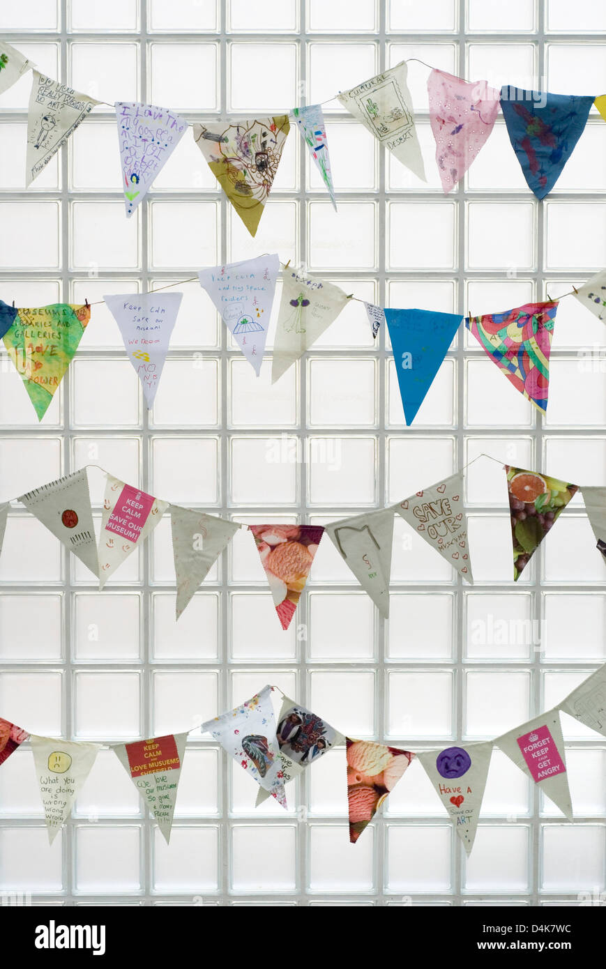 Children's art and Save Our Museum protest flags hanging before a ...