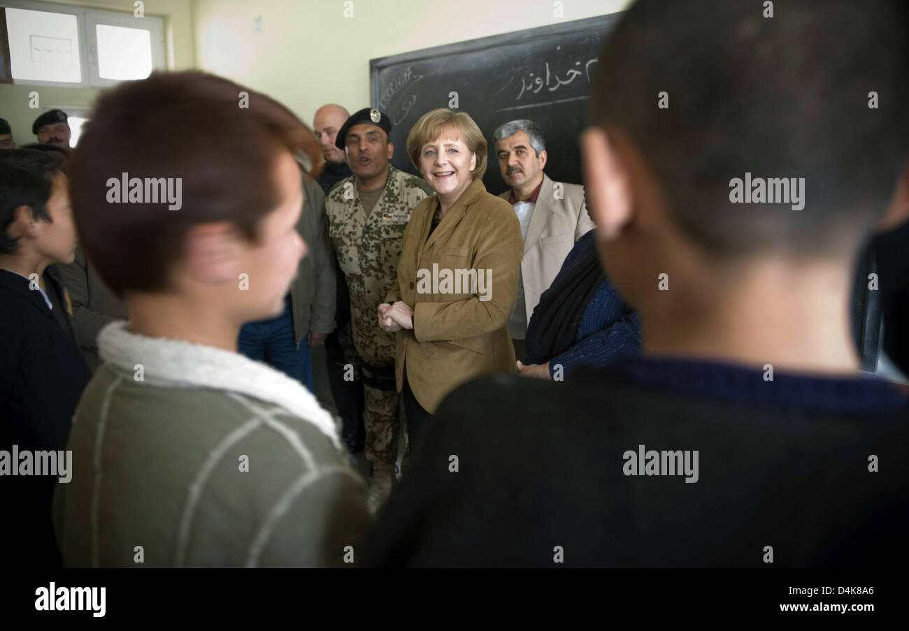 German Chancellor Angela Merkel (C) visits Ali Chapan High School in ...