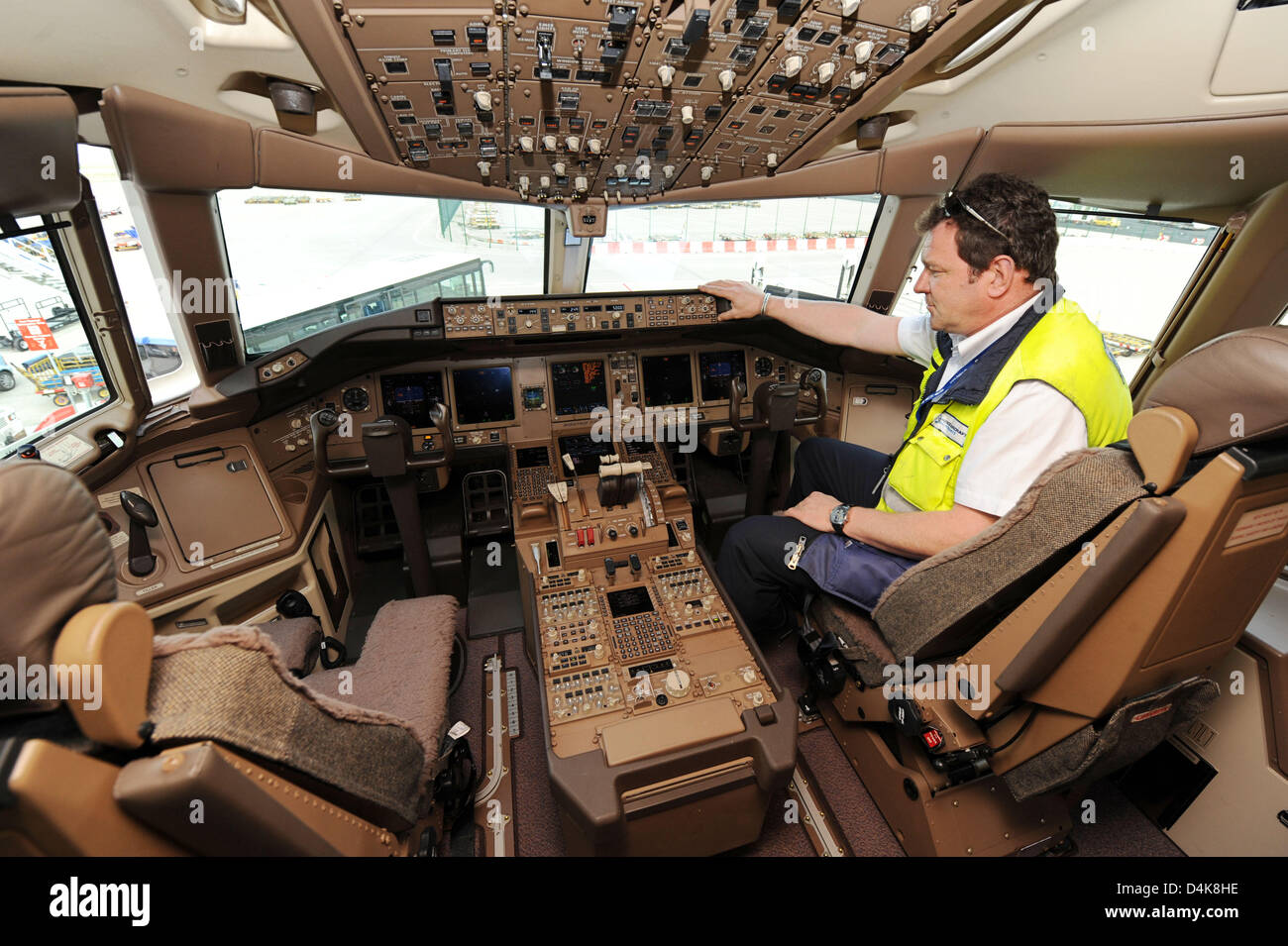 A technician checks the cockpit of a Boing 777F cargo plane of the ...