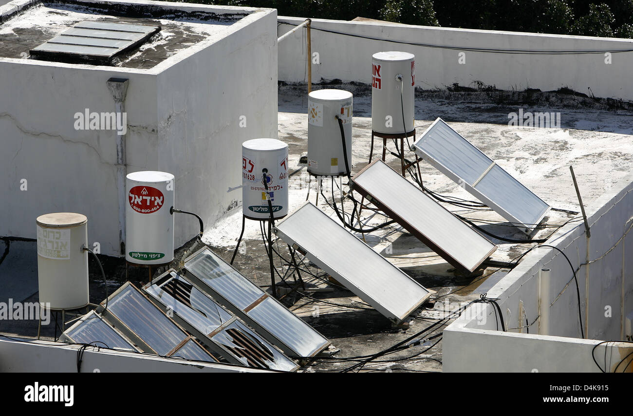 Water tanks and solar installations stand on the roof of a residence ...