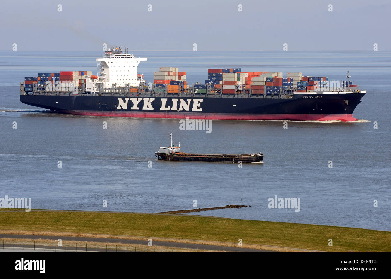 A container freighter loaded with only few containers seen on the river ...
