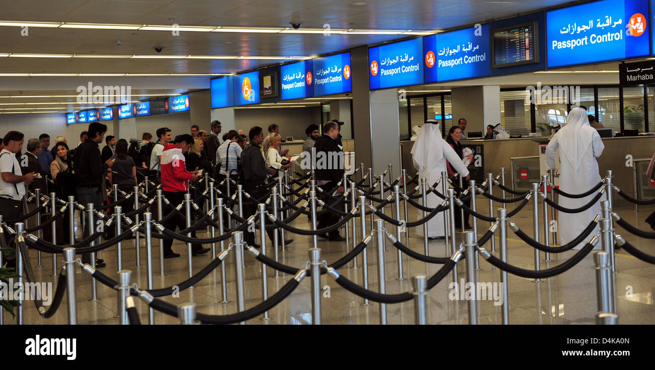 People wait at the passport control at the airport in Dubai, United ...