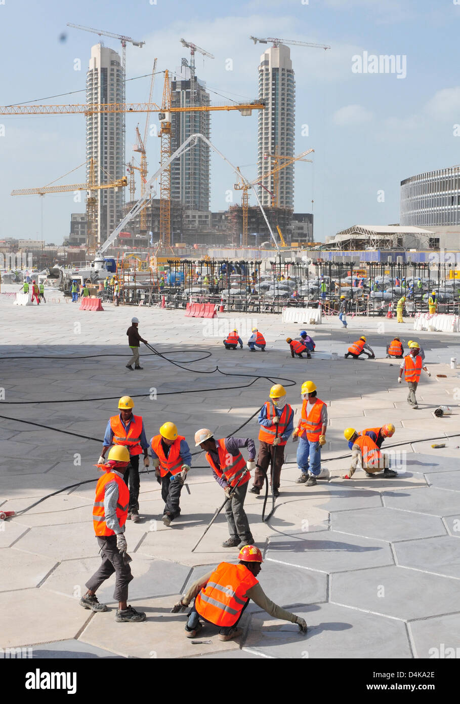 Construction workers work at the courtyard of the Burj Dubai skyscraper ...