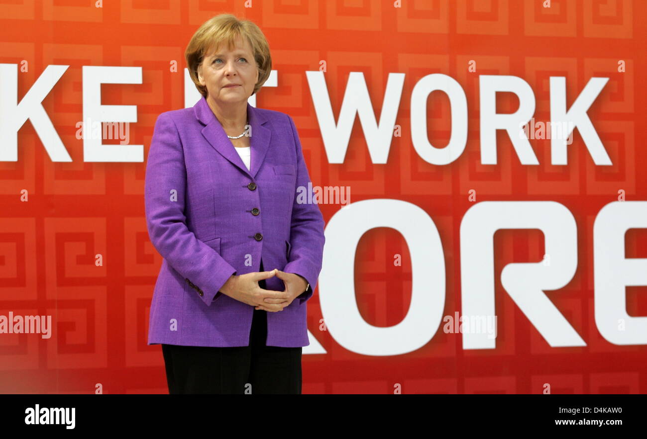 German Chancellor Angela Merkel visits the Korean booth during her ...