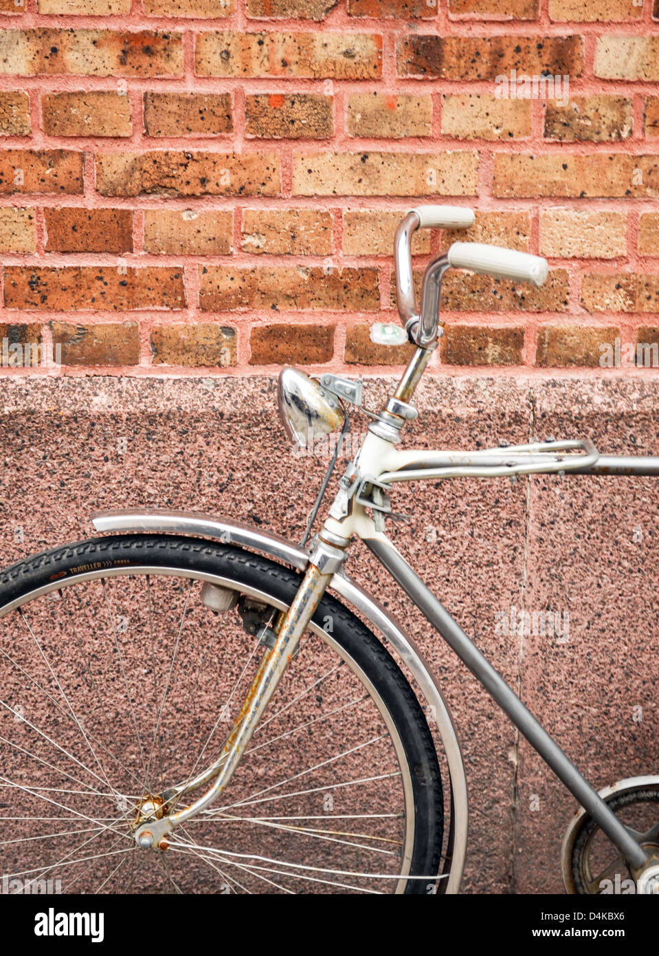 Bicycle against brick wall detail Stock Photo - Alamy