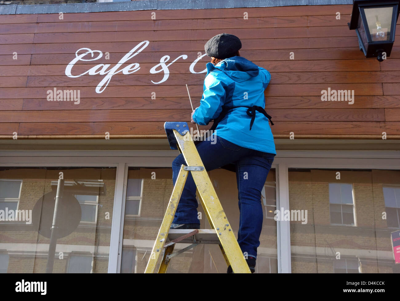Sign writer working on new cafe opening in Islington, London Stock ...