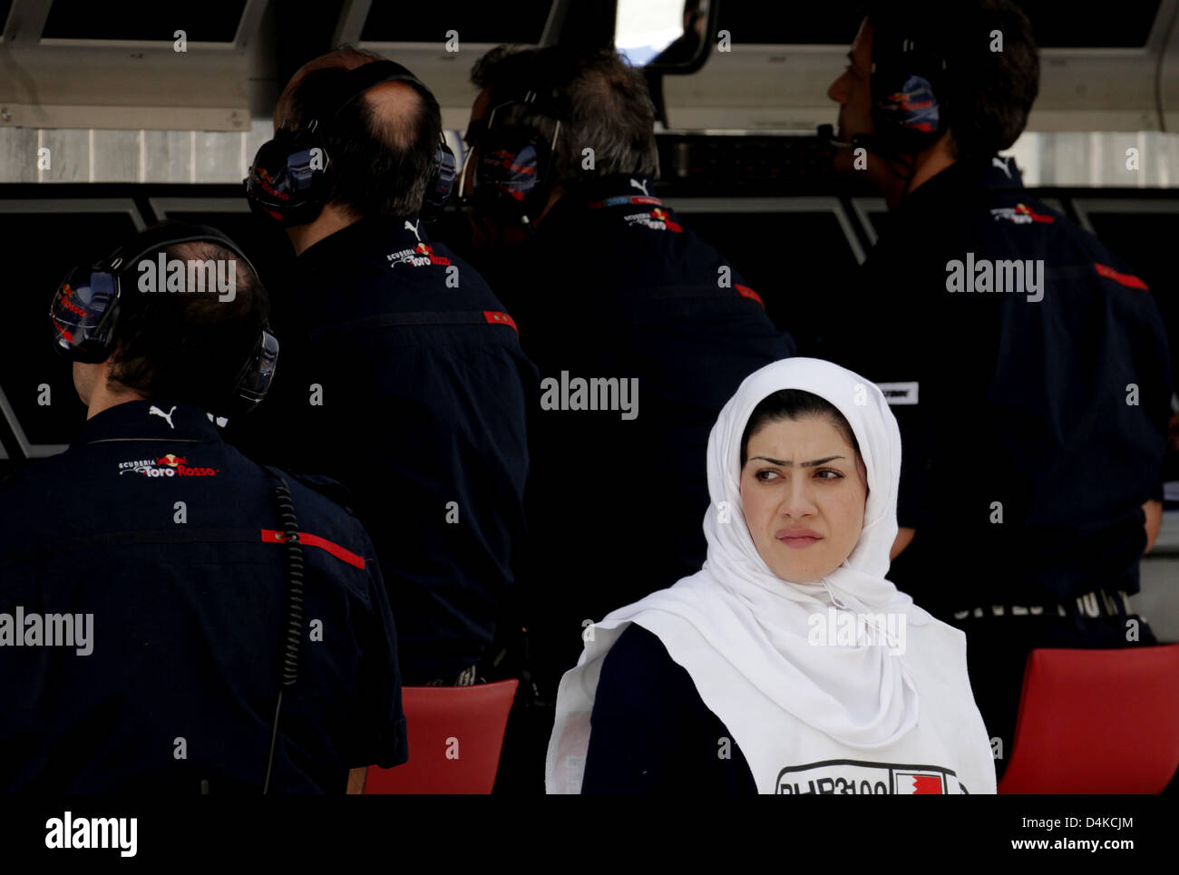 A woman stands in the pitlane next to Scuderia Toro Rosso during the ...