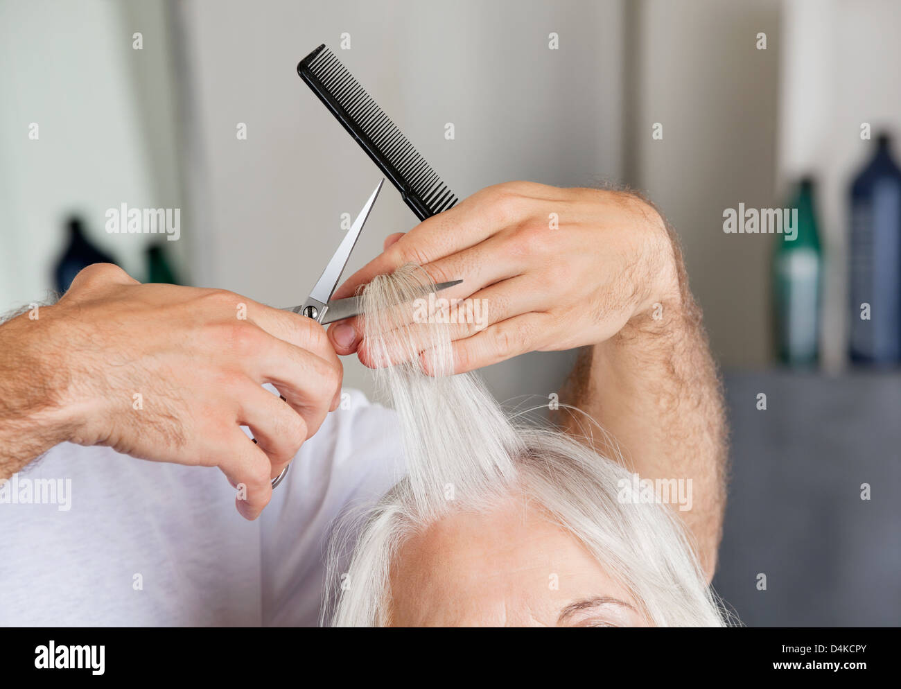 Hairdresser's Hand Cutting Hair In Parlor Stock Photo - Alamy