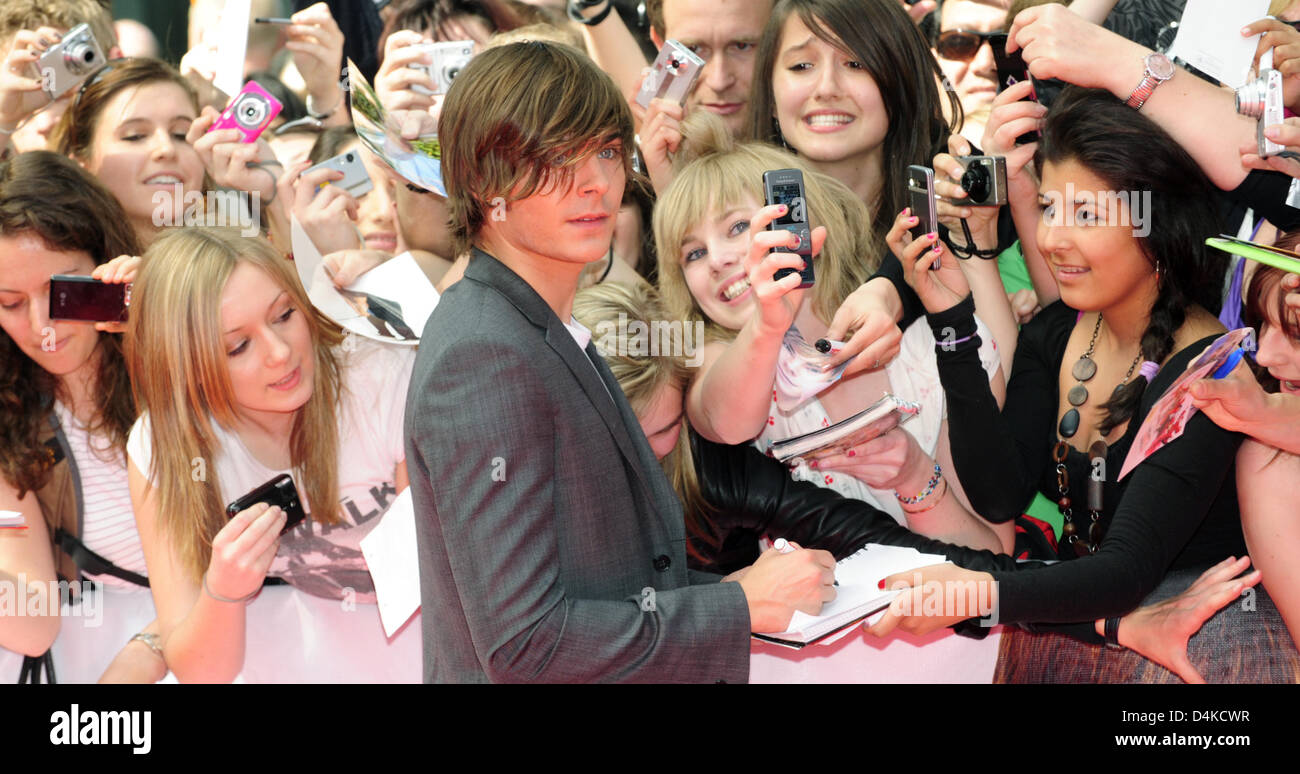 US actor Zac Efron signs autographs as he arrives for the Germany ...