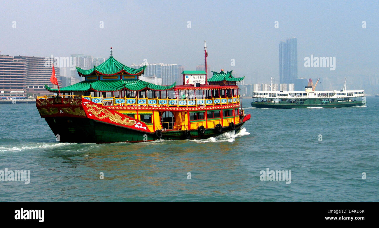 A tourist junk for harbour tours is pictured next to a regular ferry in ...