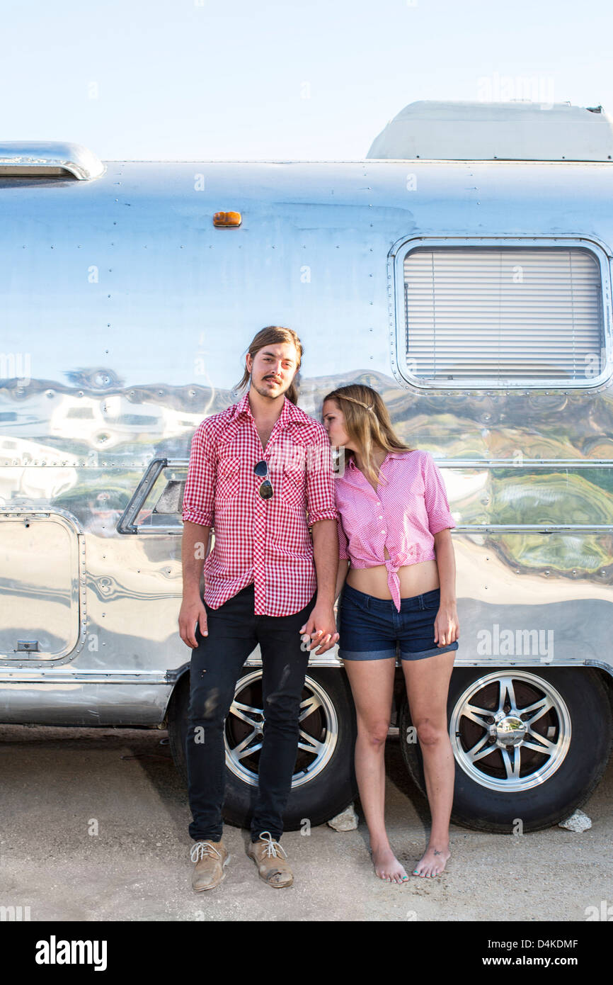 Couple standing by trailer Stock Photo - Alamy