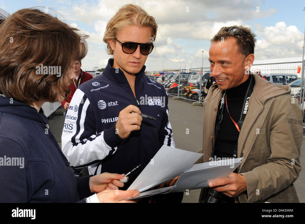 German Formula One driver Nico Rosberg (C) of Williams F1 signs ...