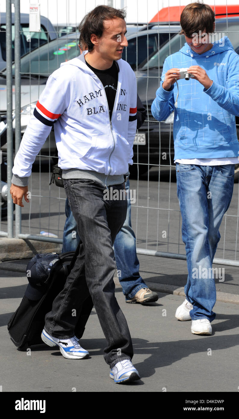 Polish Formula One driver Robert Kubica of BMW Sauber walks through the ...