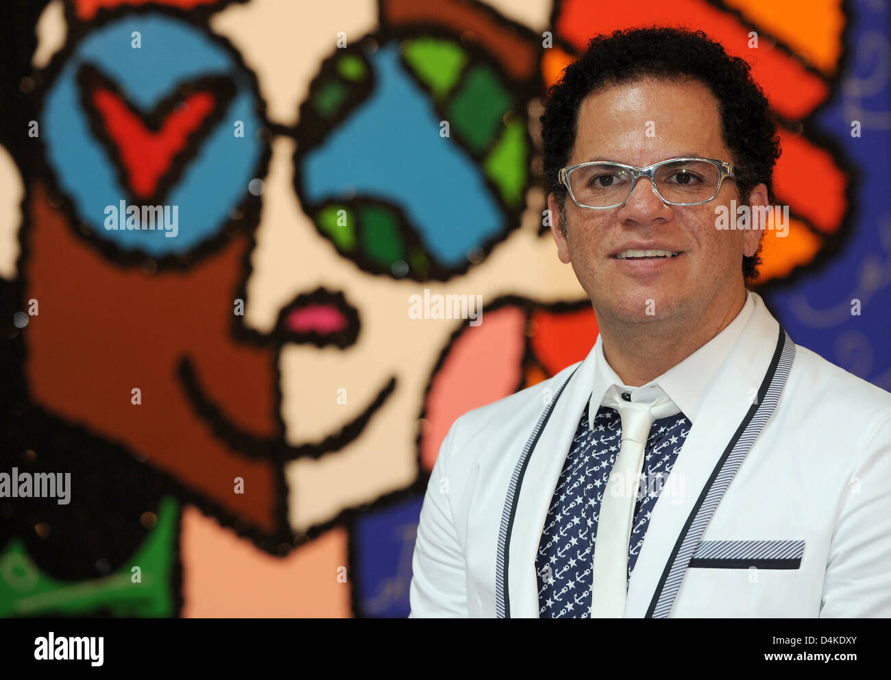Brazilian artist Romero Britto stands in front of one of his paintings ...