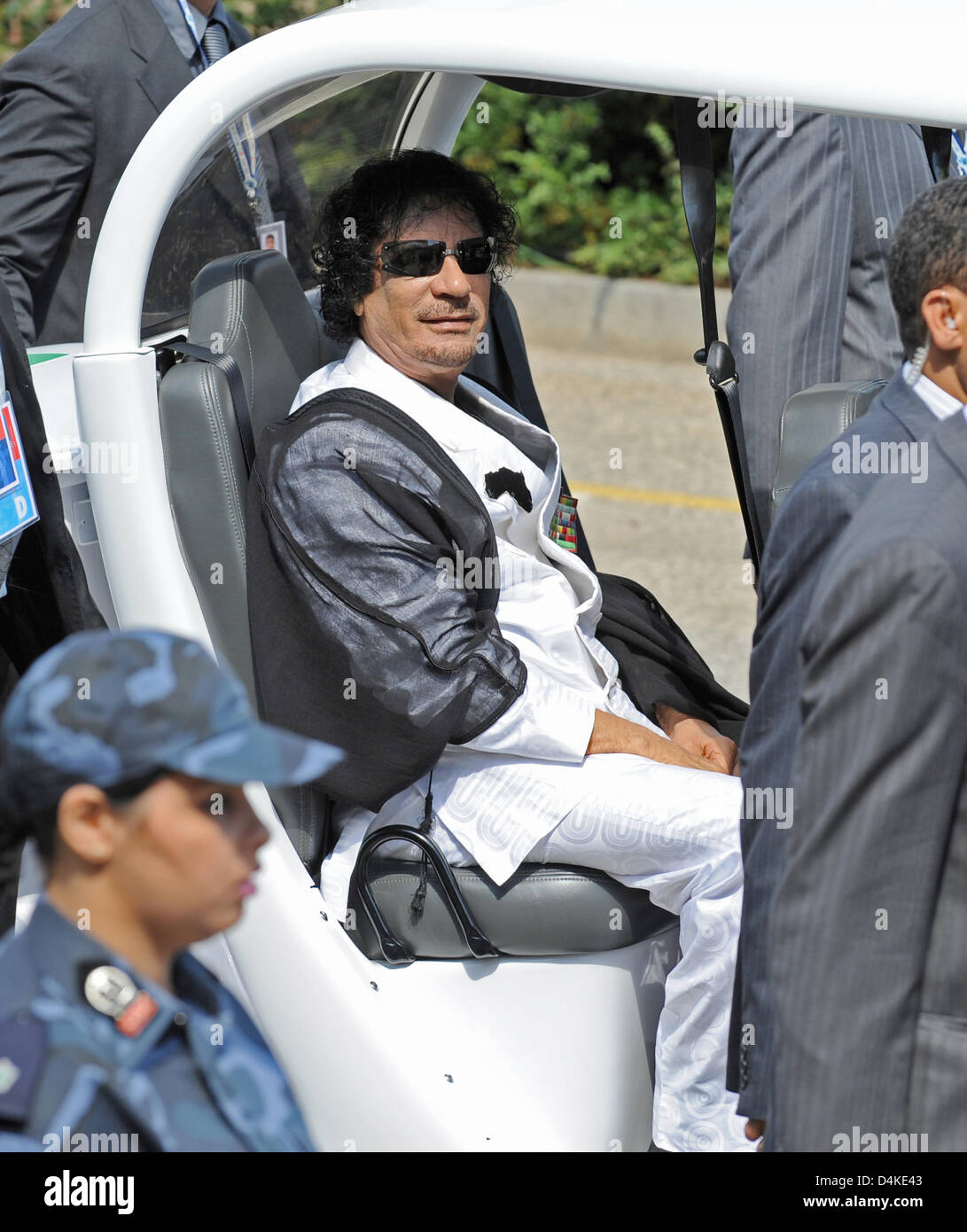 In an electric car and surrounded by security officers, Libyan ...