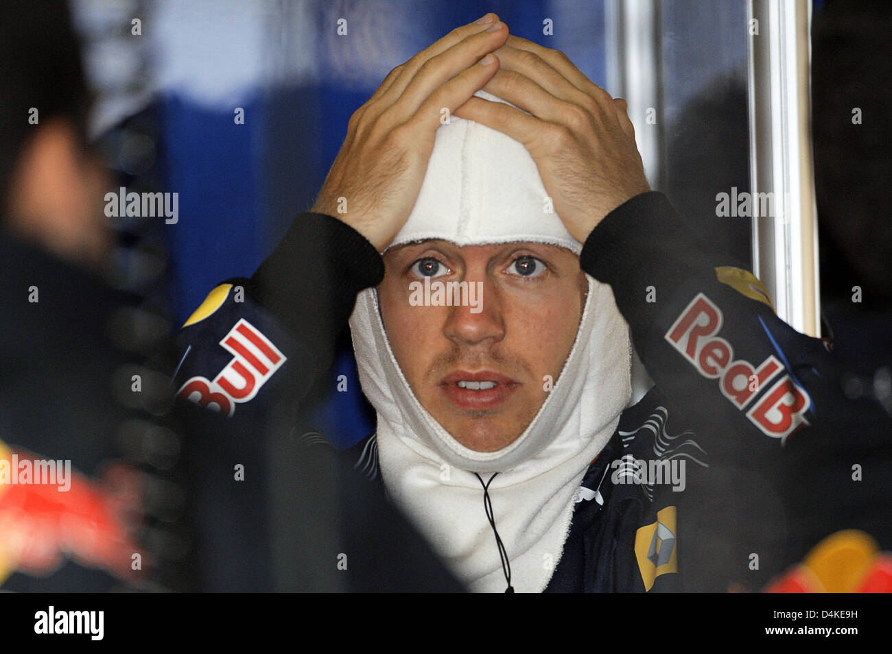 German Formula One driver Sebastian Vettel of Red Bull Racing adjusts ...