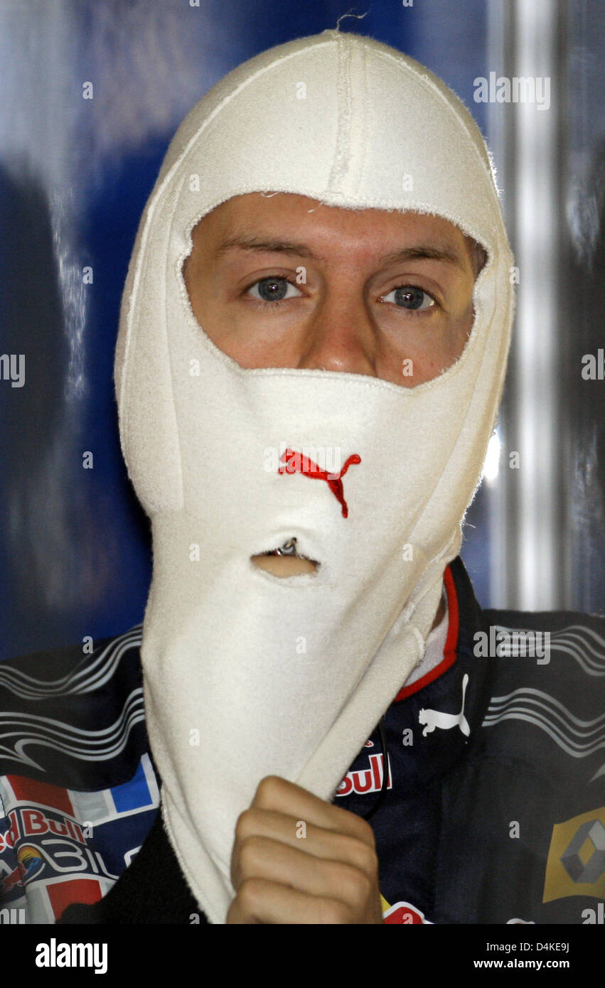 German Formula One driver Sebastian Vettel of Red Bull Racing adjusts ...