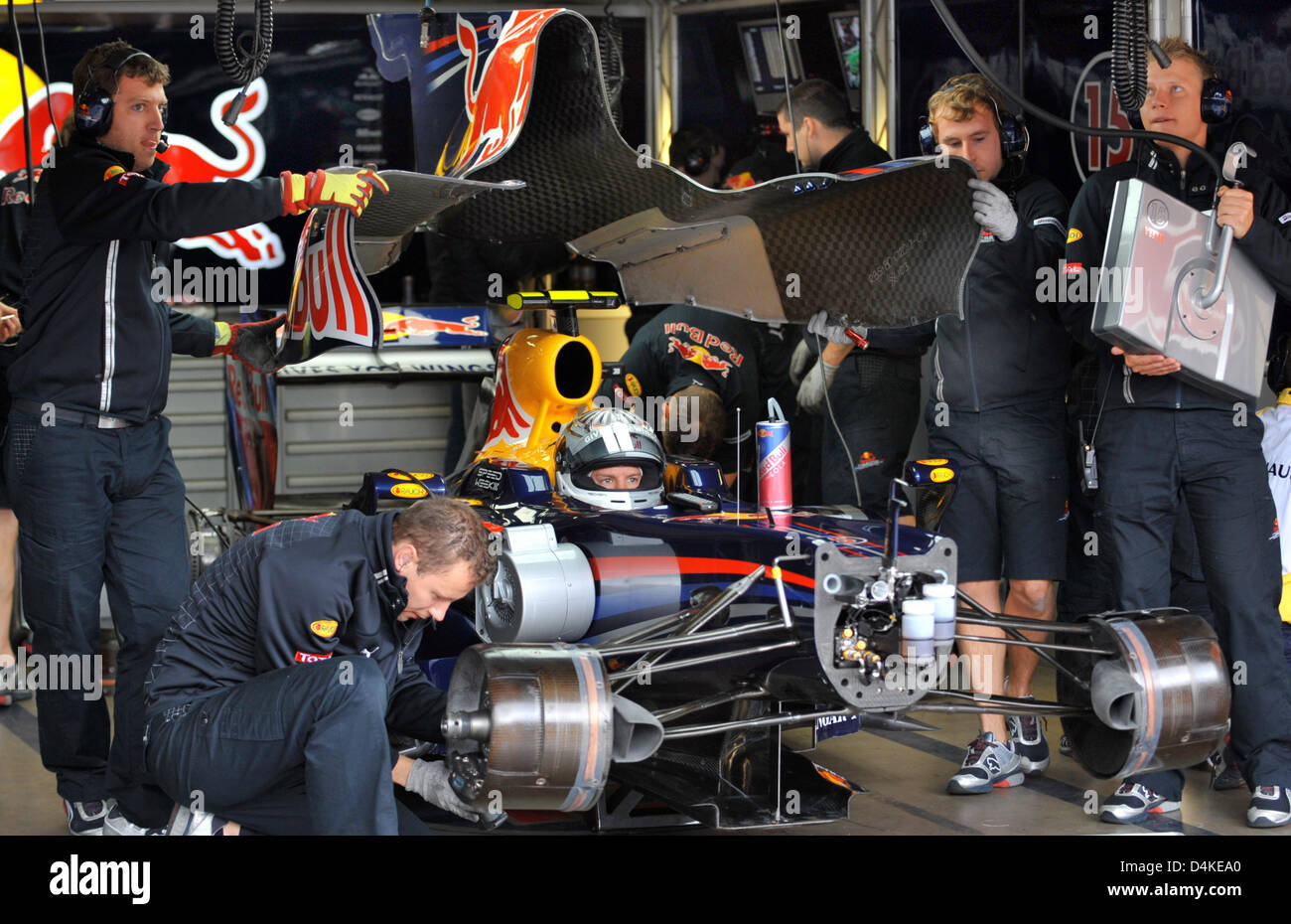 Mechanics prepare the racing car of German Formula One driver Sebastian ...