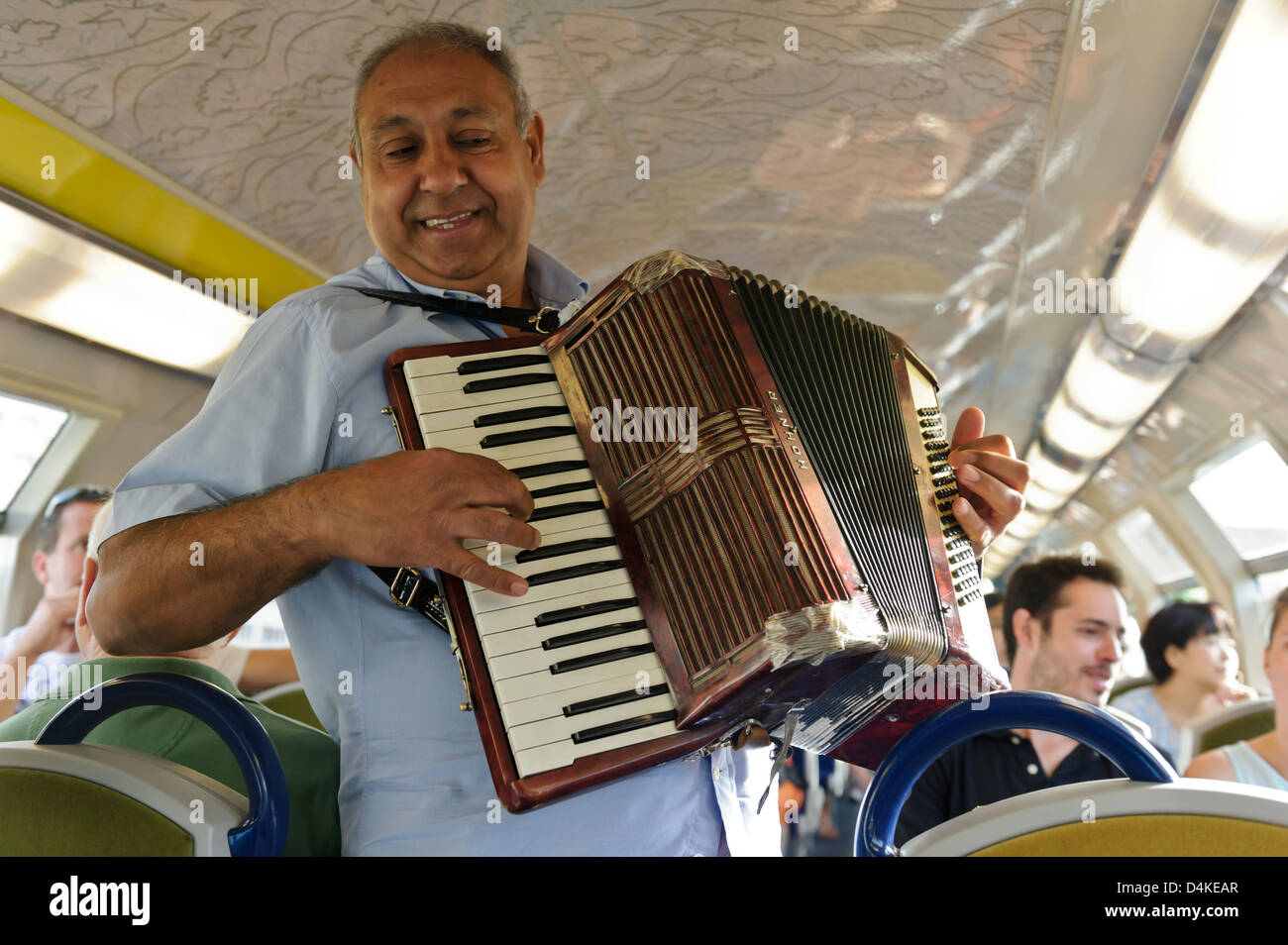 Musician playing accordion on train, Paris, France Stock Photo - Alamy