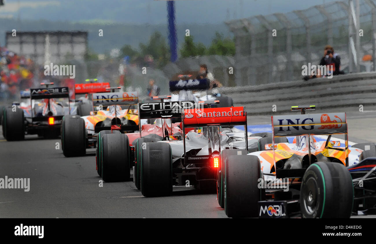 Race cars wait for the start of the qualifying session for the Grand ...