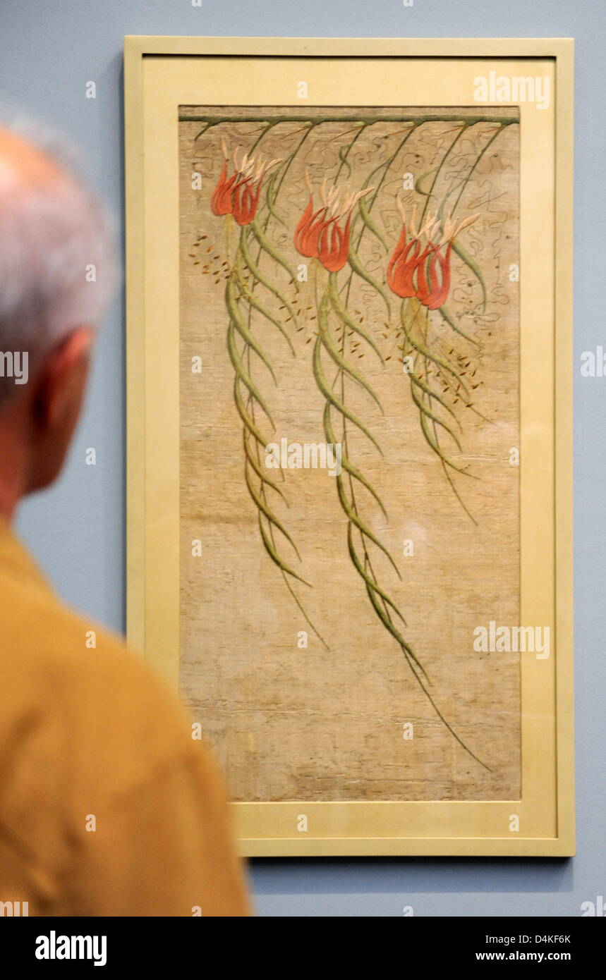 A man takes a look at a wallhanging during a private view of the ...