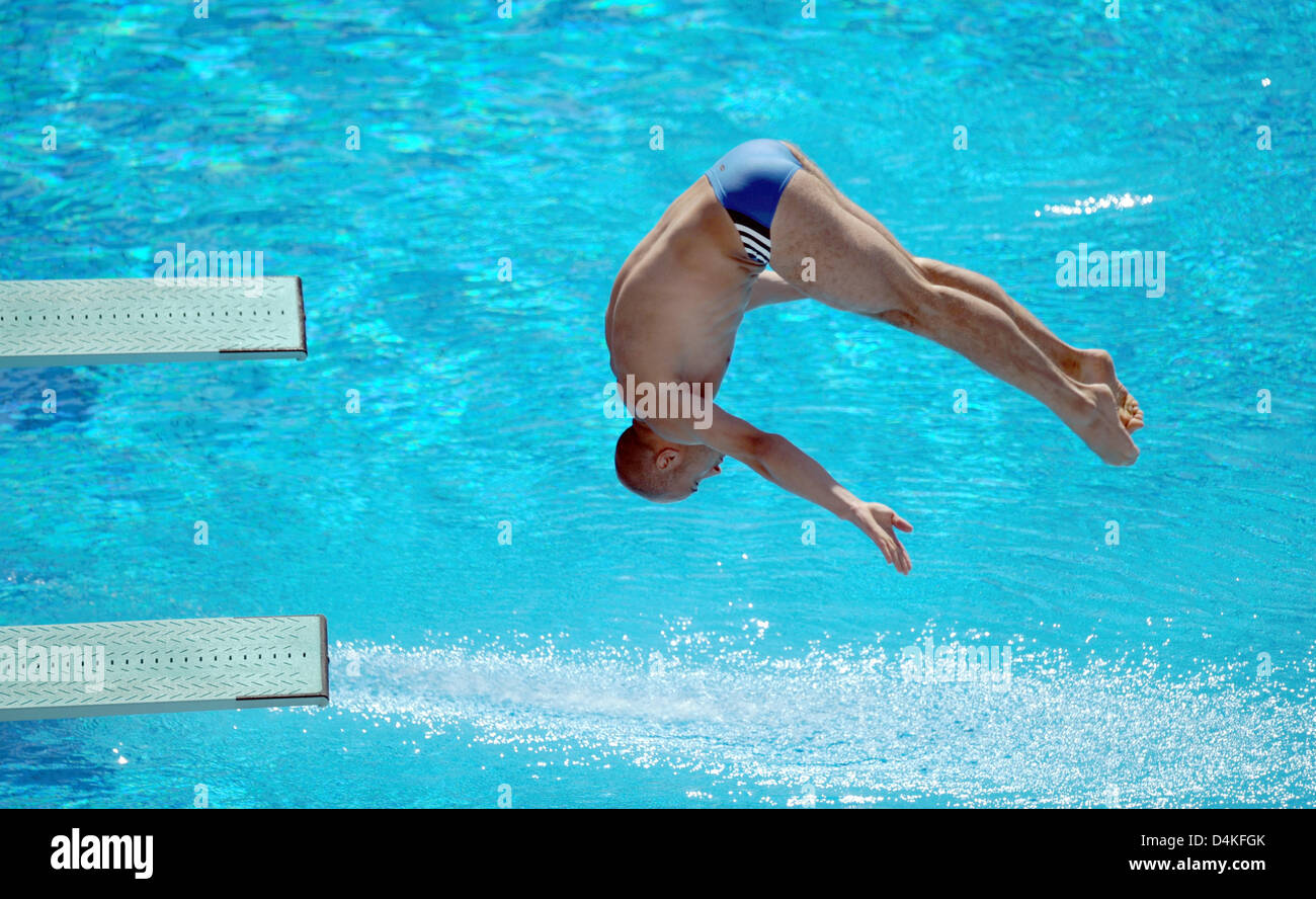 German diver Pavlo Rozenberg jumps off the 1m diving board during the ...