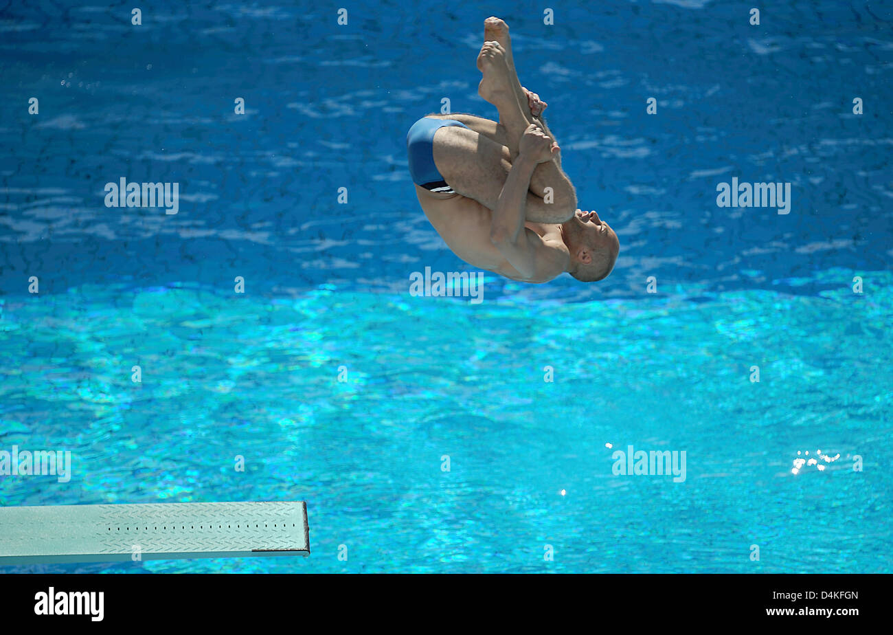 German diver Pavlo Rozenberg jumps off the 1m diving board during the ...