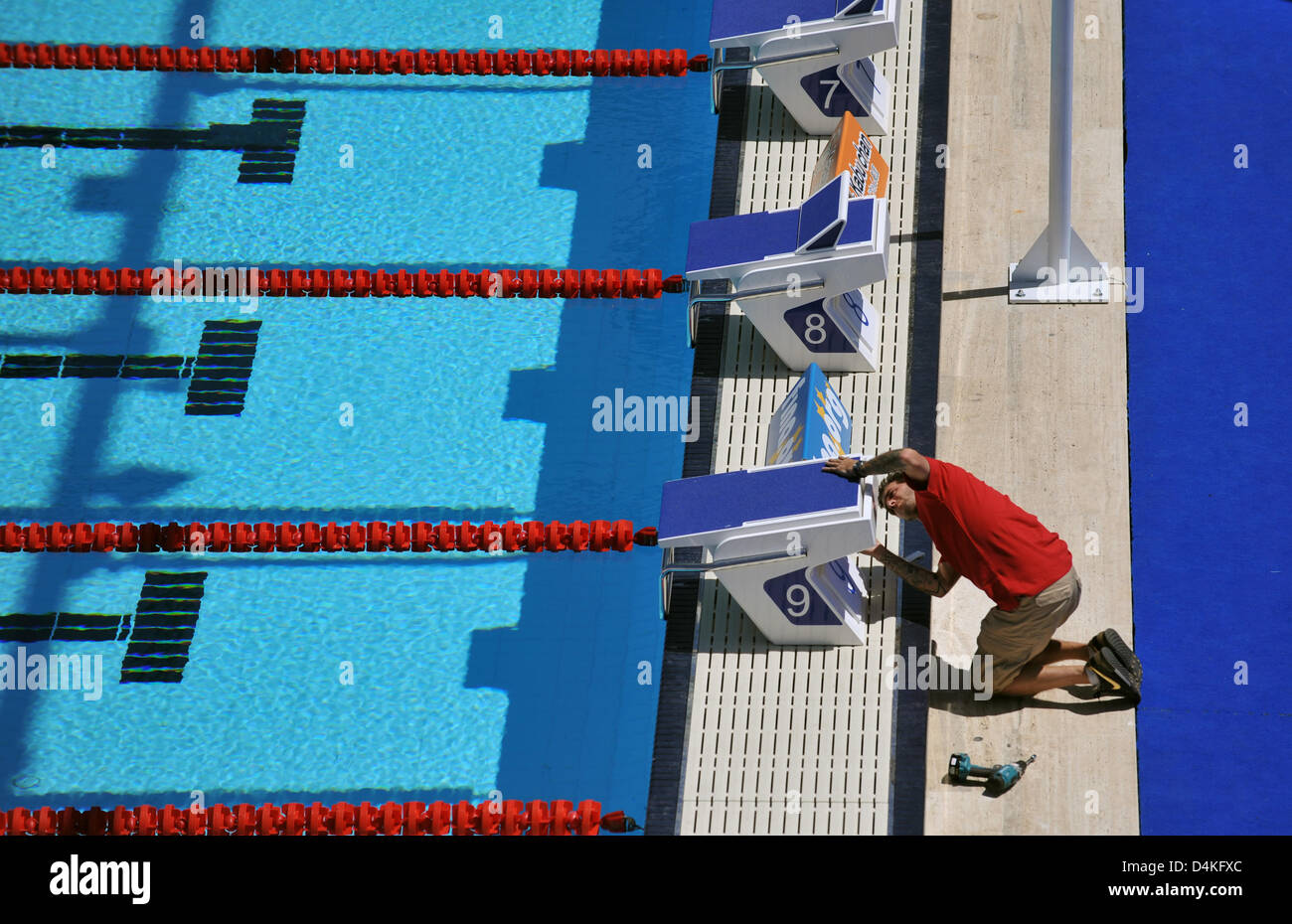 A staff member of time measurement comapny Omega adjusts starting ...
