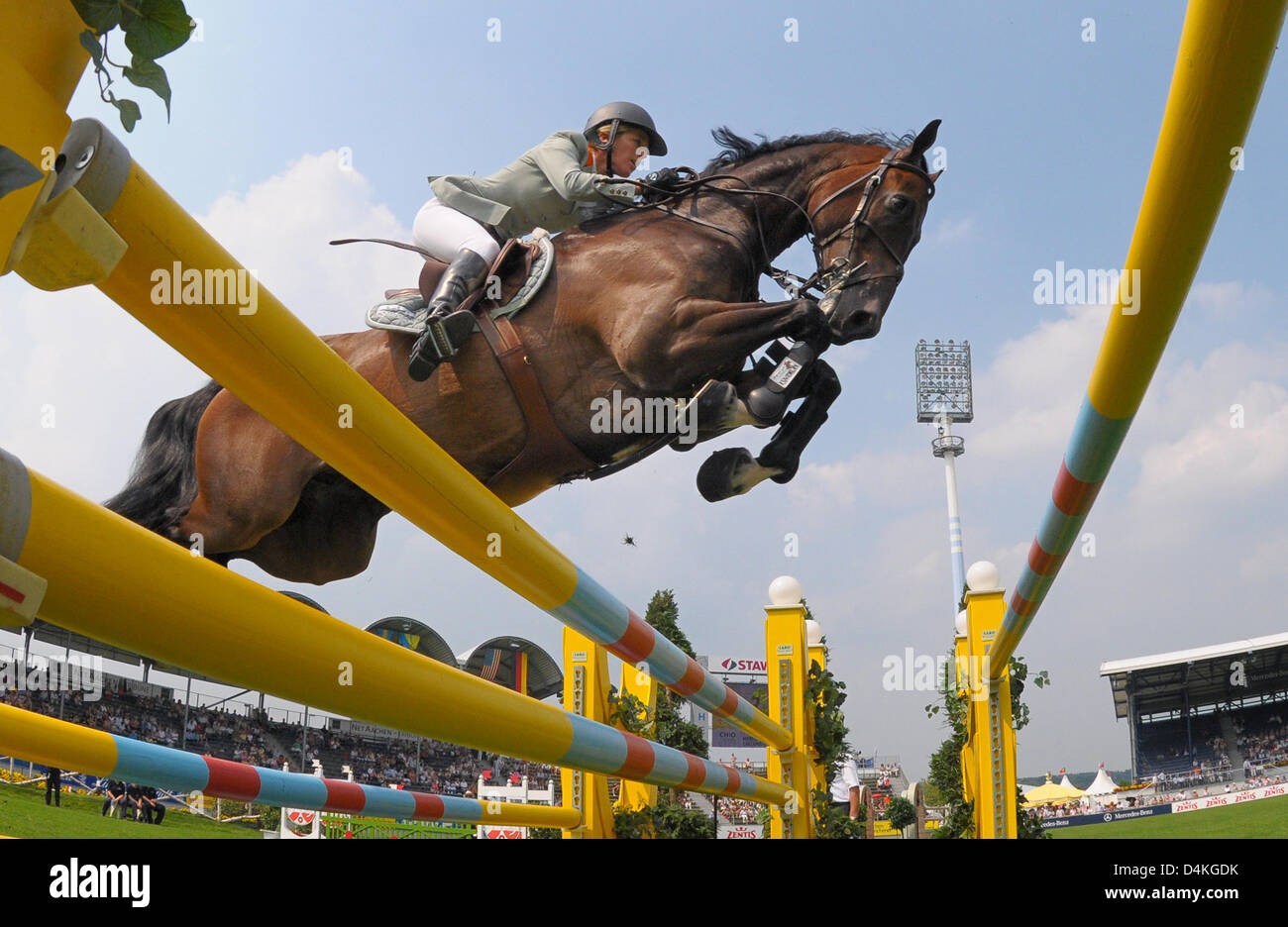 Meredith Michaels-Beerbaum from Germany clears an obstacle on her horse ...
