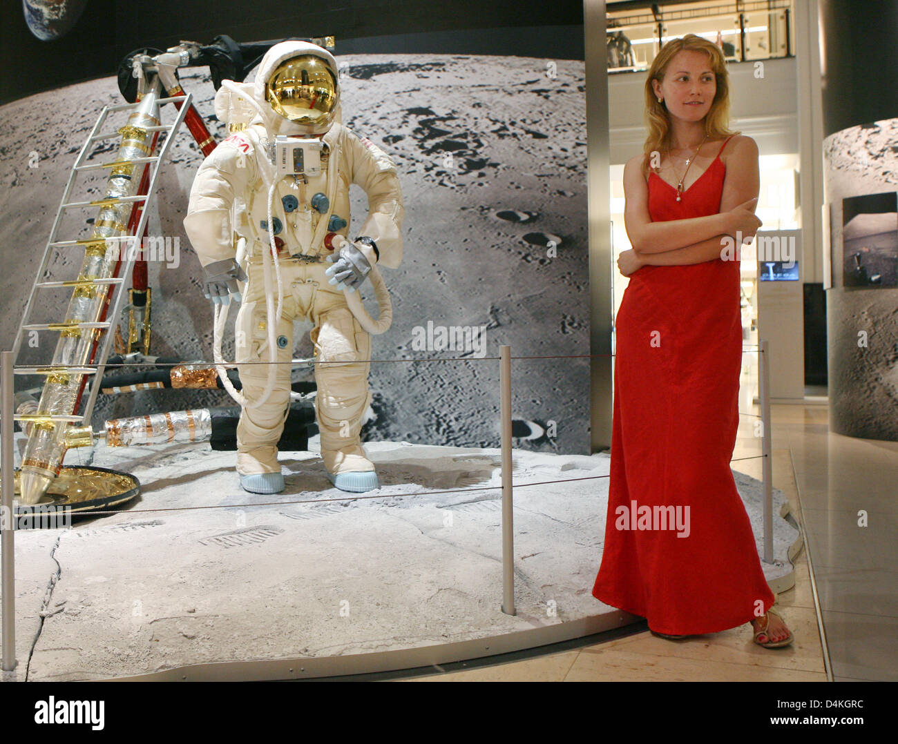 Olga from Moscow poses next to a space suit in the department store ...