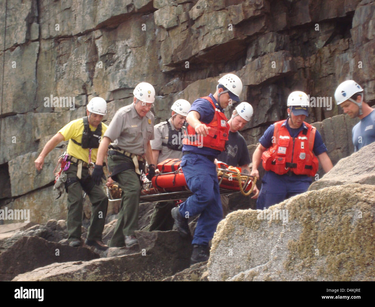 Park service and Coast Guard personnel help an injured rock climber ...