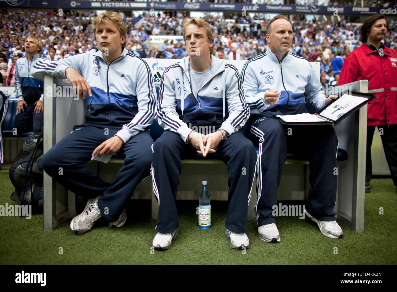 Schalke coaches Youri Mulder (L-R), Mike Bueskens and Oliver Reck sit ...
