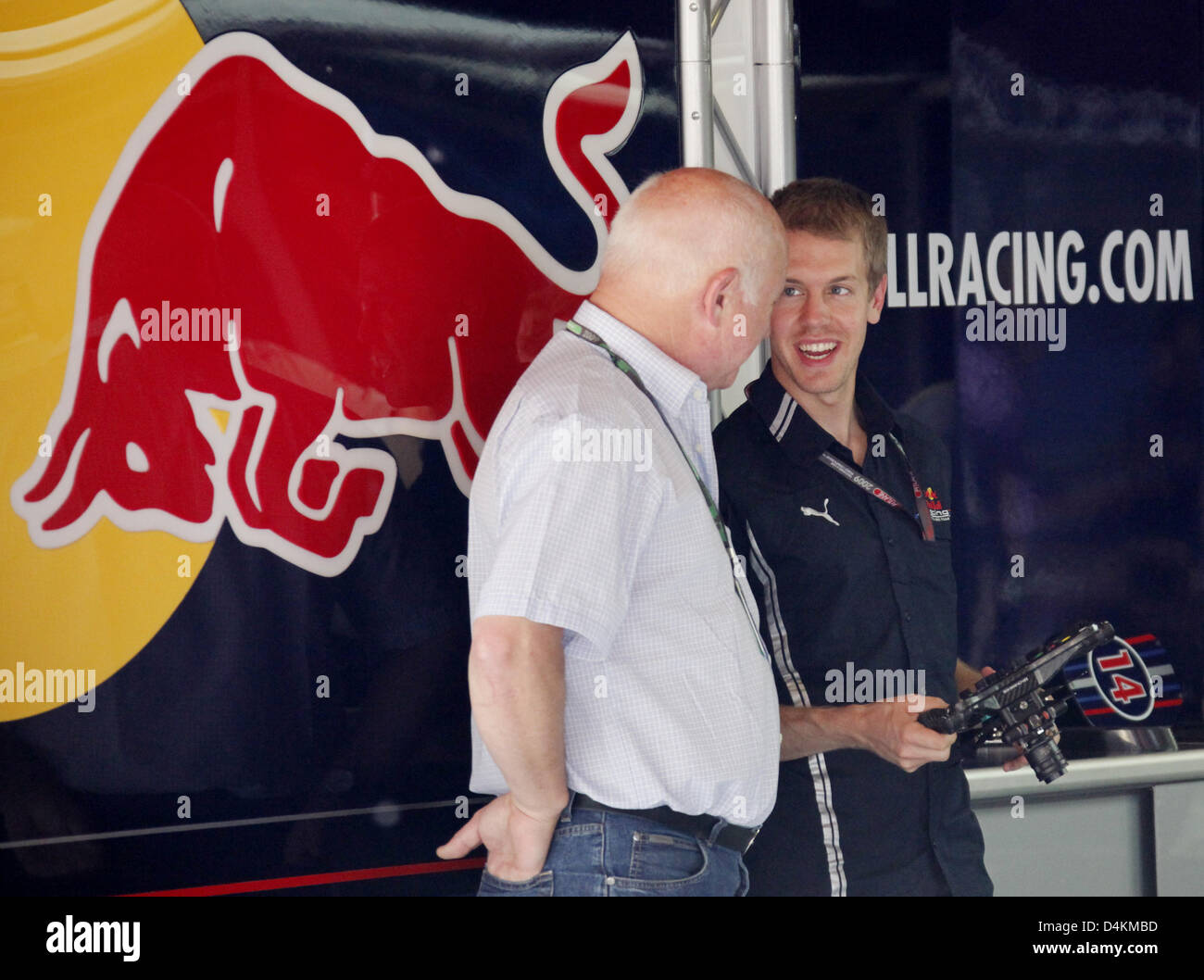 German Formula One driver Sebastian Vettel (R) of Red Bull Racing talks ...