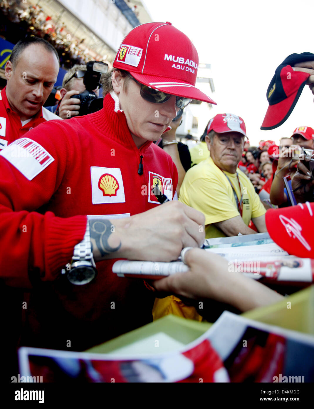Finnish Formula One driver Kimi Raikkonen of Scuderia Ferrari signs ...