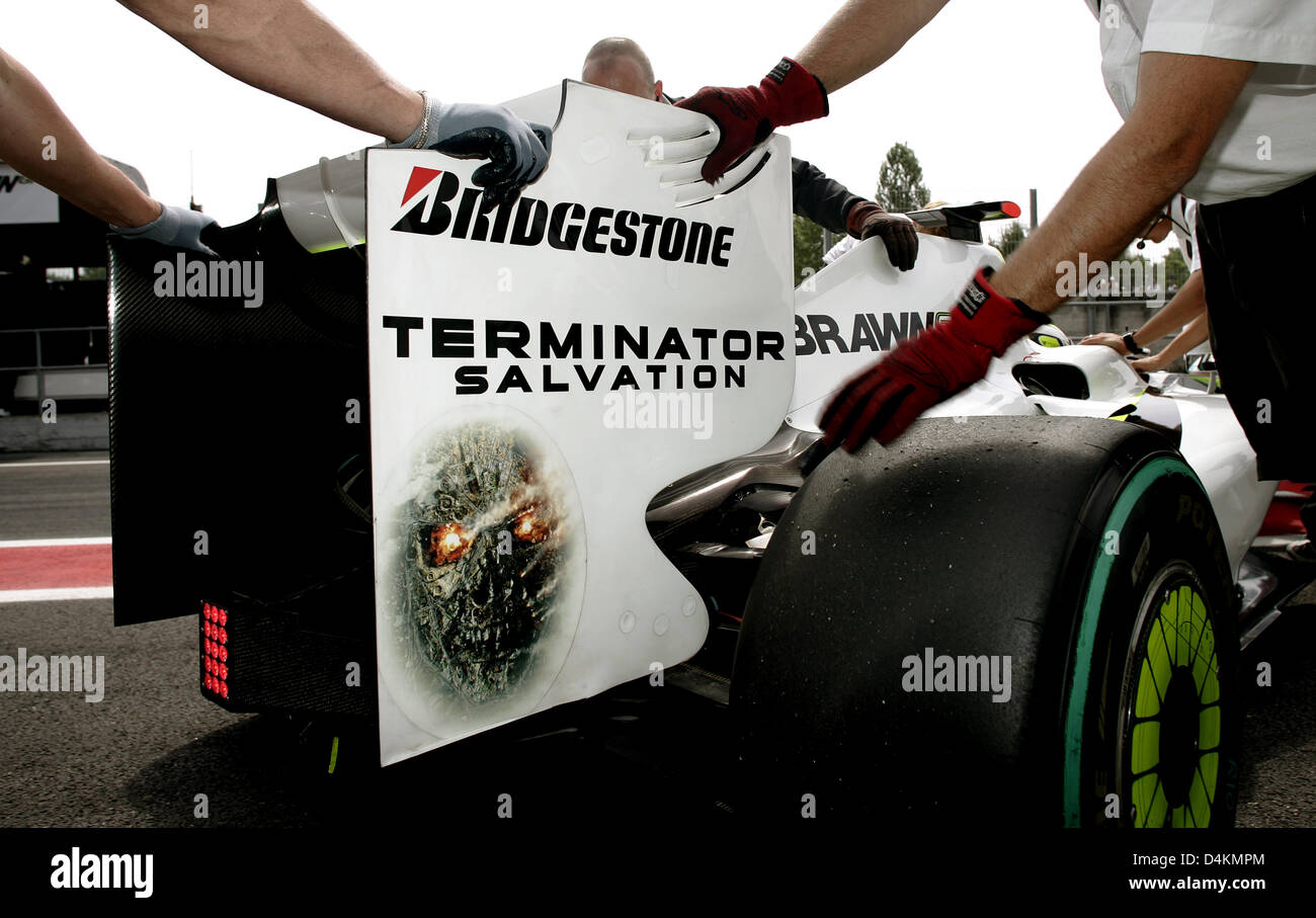 Mechanics of Brawn GP push Brazilian Formula One driver Rubens ...