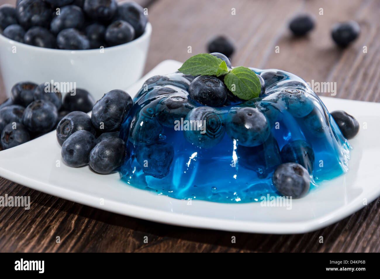 Portion of Blueberry Jello on wooden background Stock Photo - Alamy
