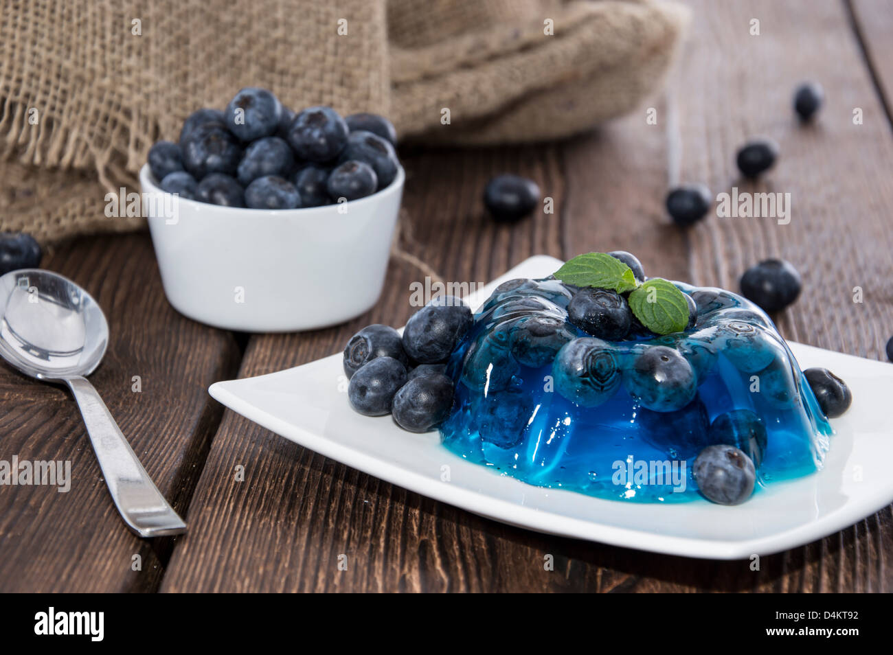 Portion of Blueberry Jello on wooden background Stock Photo - Alamy