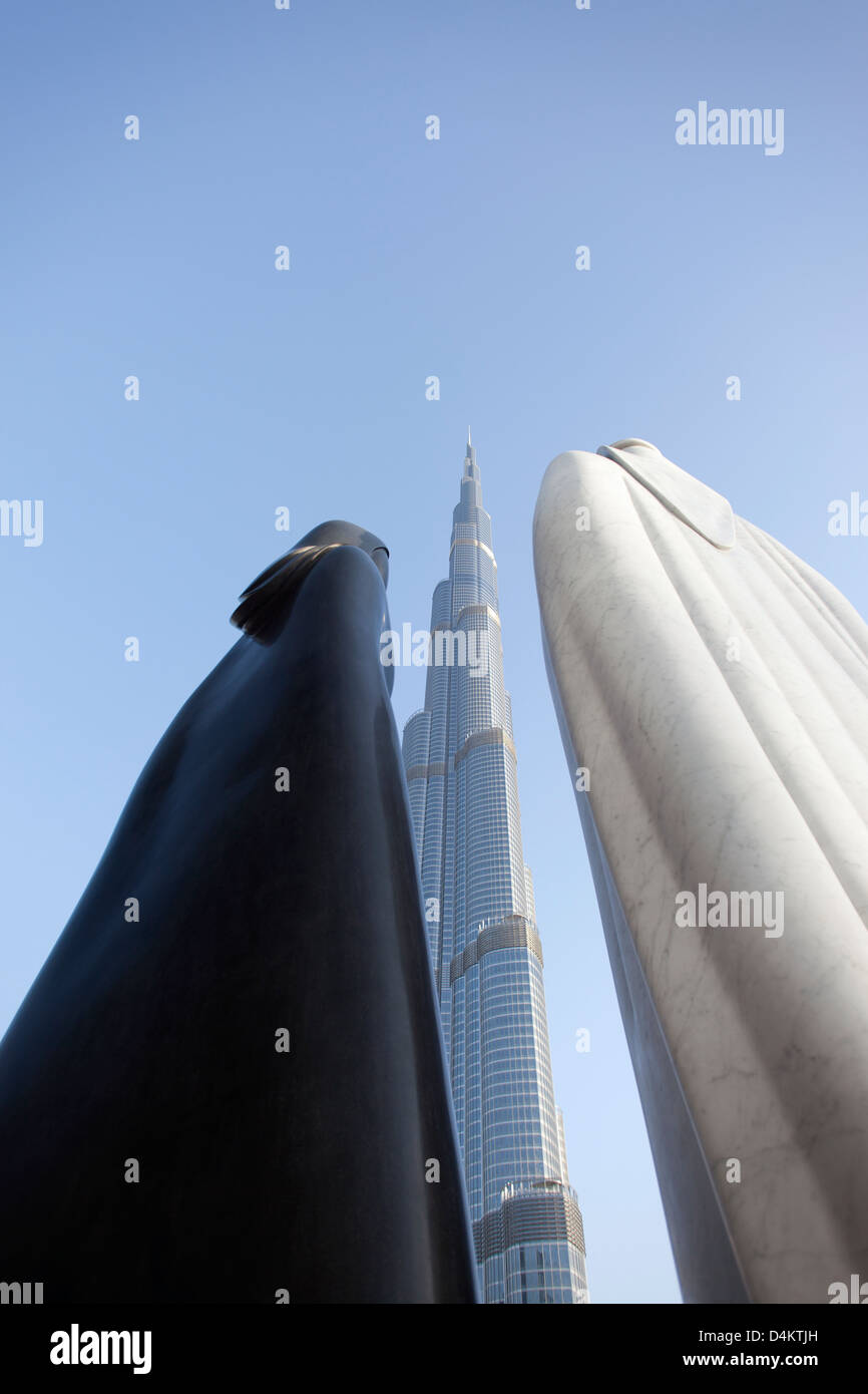 UAE, Dubai, statue 'Together' by Lutfi Romhein with the Burj Khalifa ...