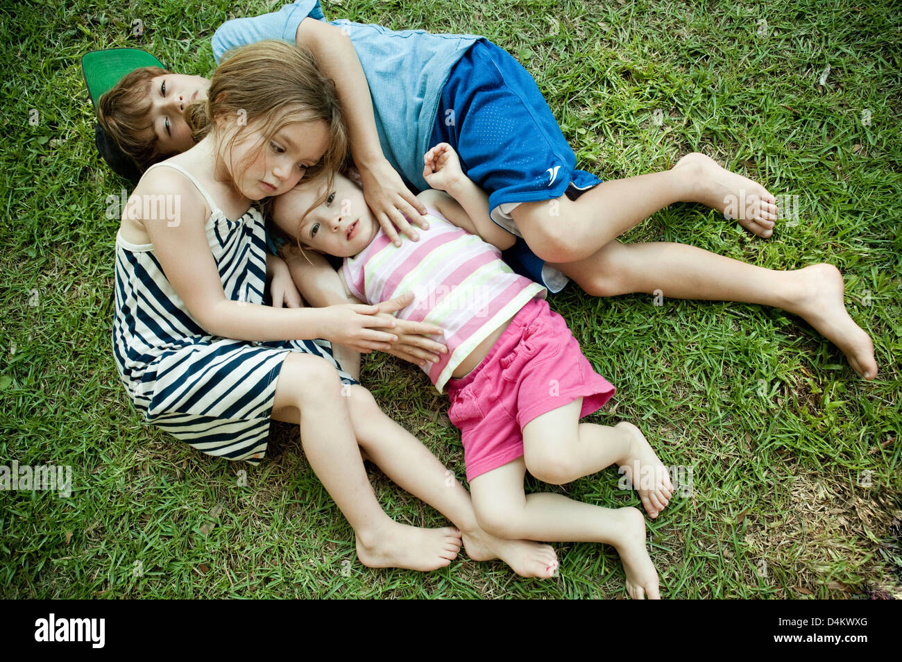 Children laying in grass together Stock Photo - Alamy