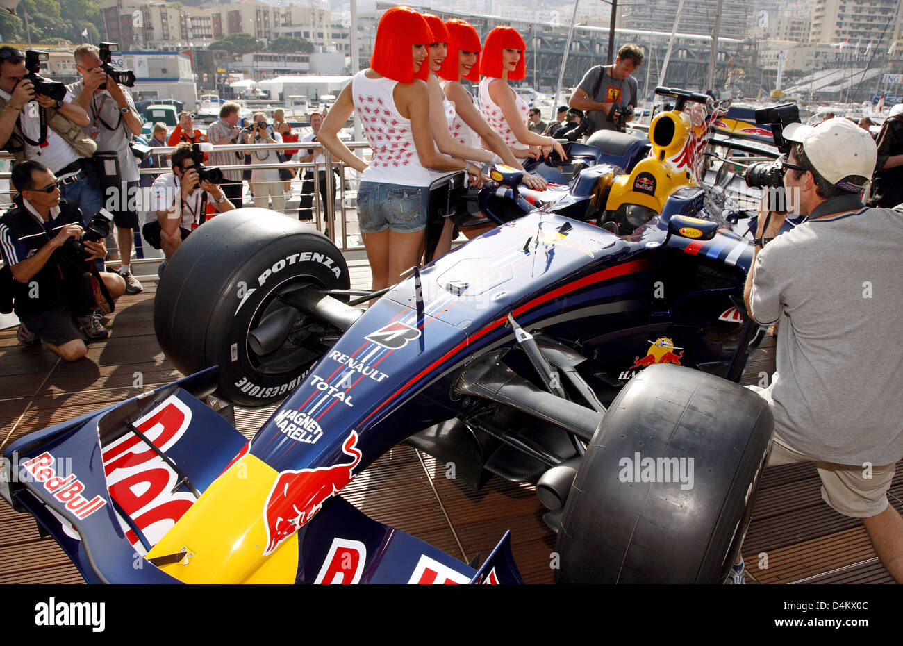 Models pose in front of a racecar of Red Bull Racing in Monte Carlo ...