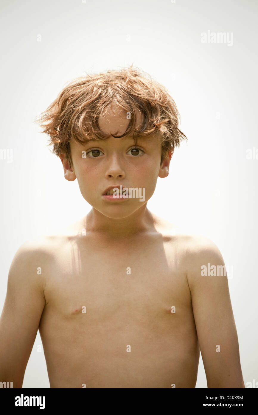 Bare-chested boy standing outdoors Stock Photo - Alamy