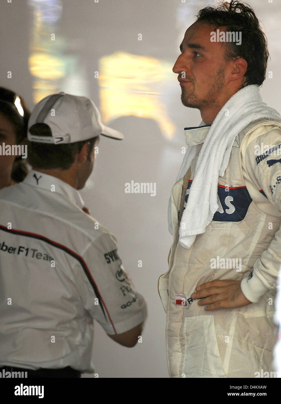 Polish Formula One driver Robert Kubica of BMW Sauber stand in his pit ...